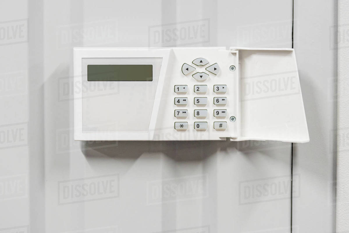 home security alarm on white wall, security system concept - Royalty ...