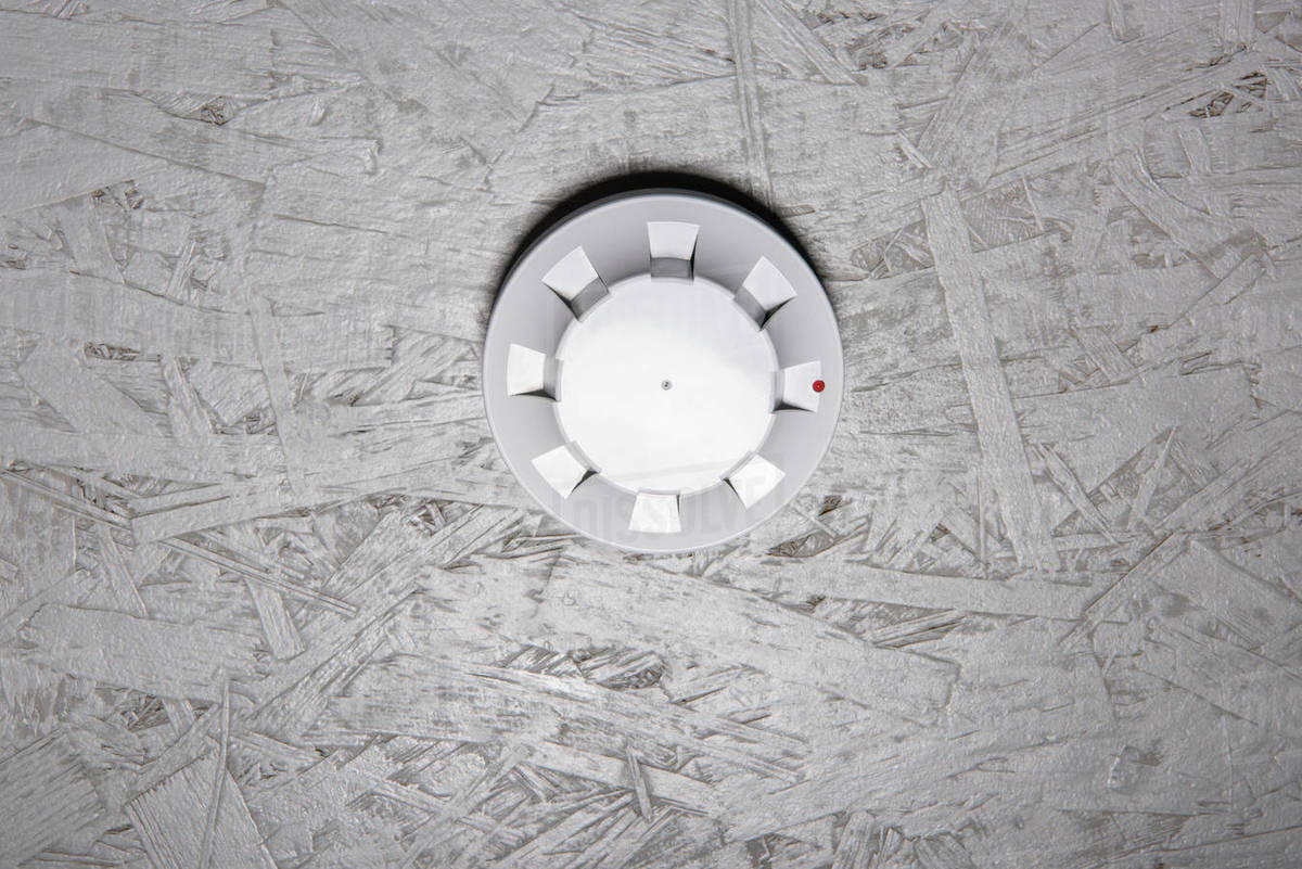 smoke detector of fire alarm on white ceiling at home - Royalty-free ...