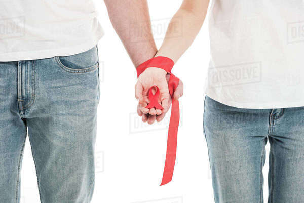 Cropped shot of couple holding hands tied with red ribbon isolated on ...