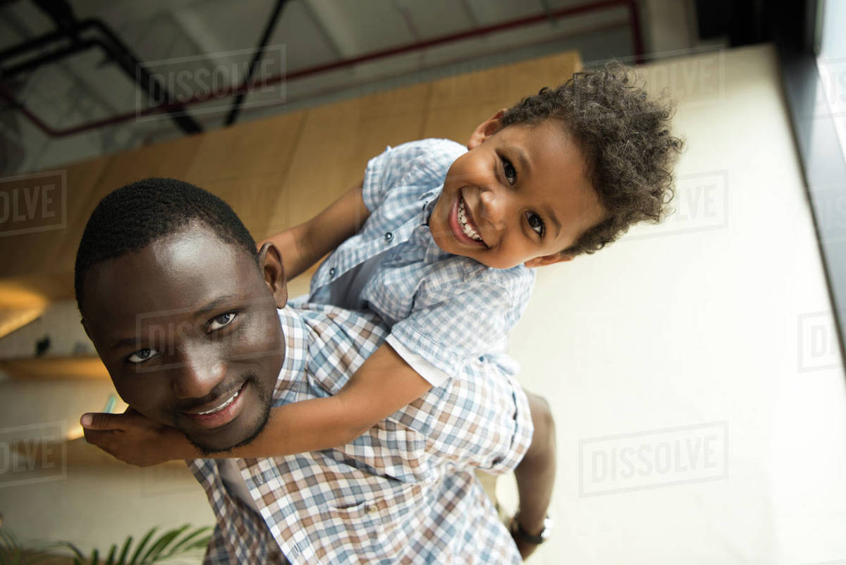 Low angle view of happy African American father and embracing and ...