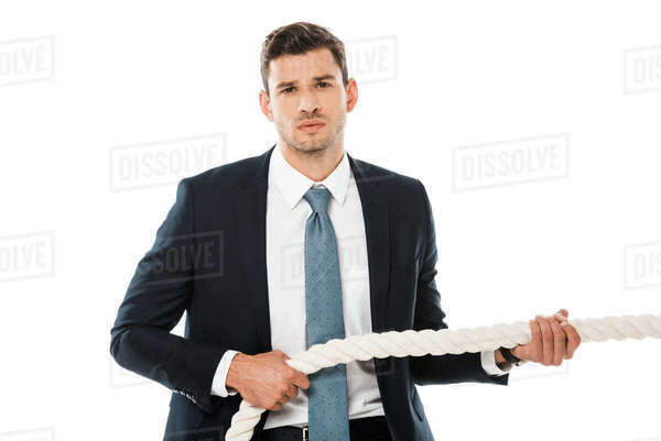 tense businessman pulling rope and looking at camera isolated on white ...