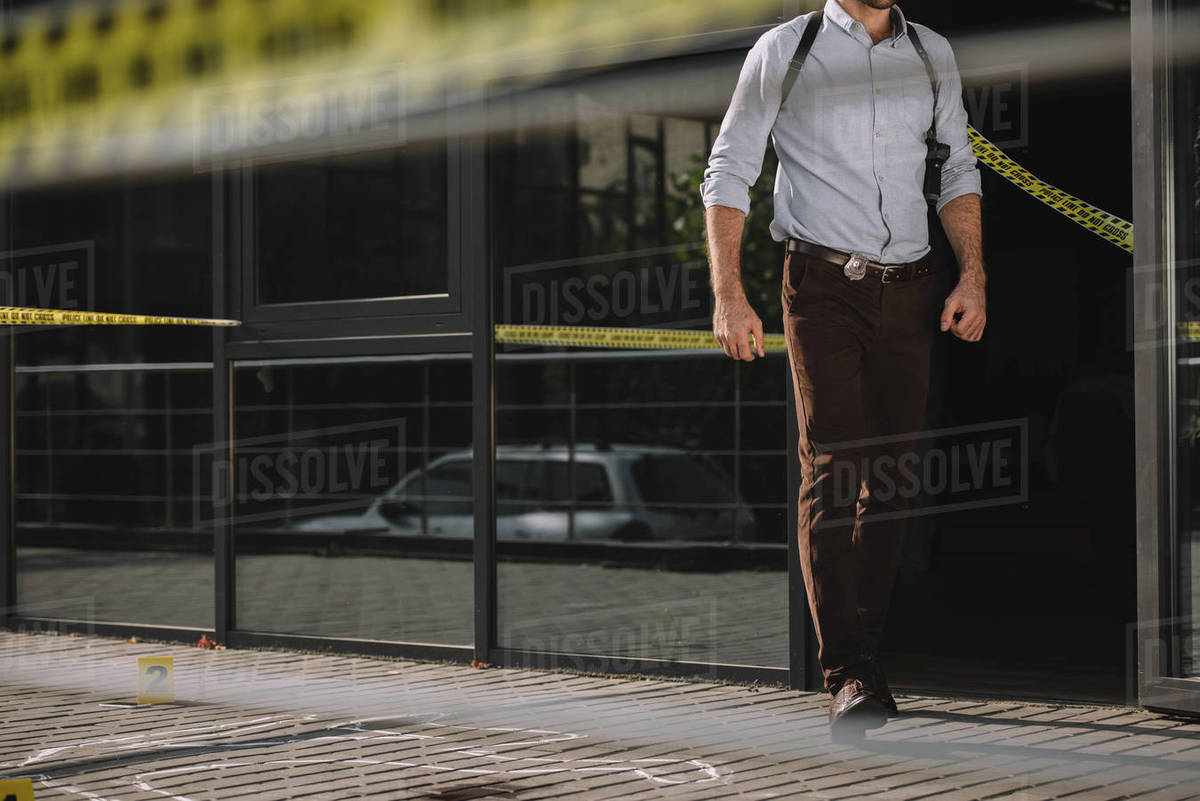 Cropped view of male detective walk through the crime scene - Royalty ...