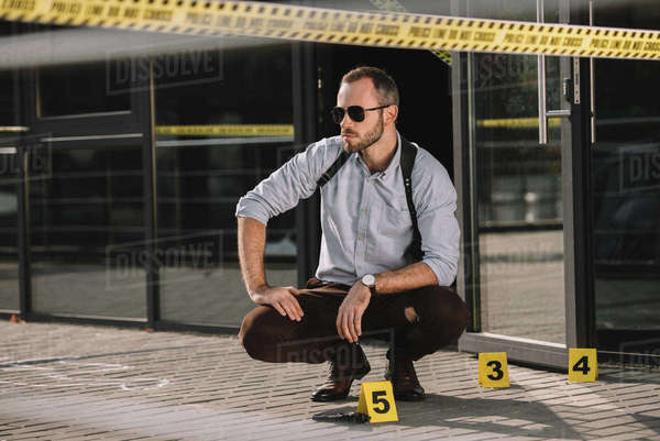 Thoughtful male detective sitting at crime scene - Royalty-free Stock ...