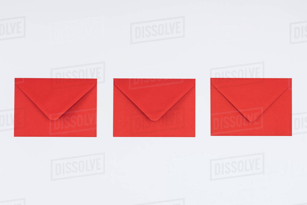 close-up view of three closed red envelopes isolated on white ...