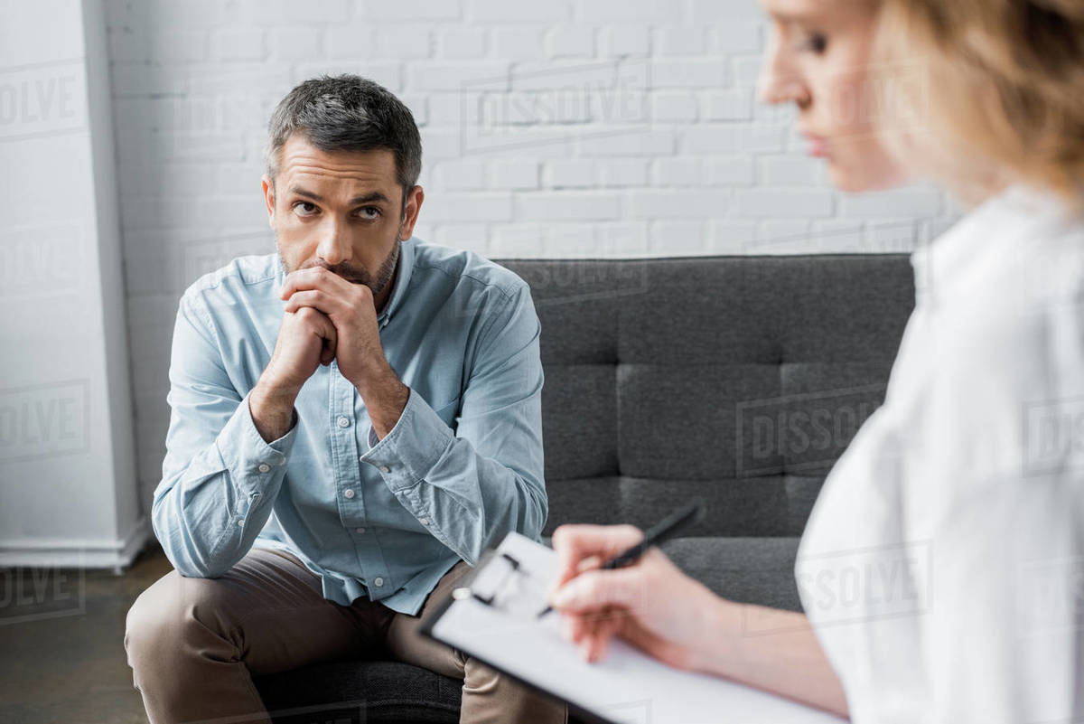 Sad adult man on psychologist therapy session at office - Royalty-free ...