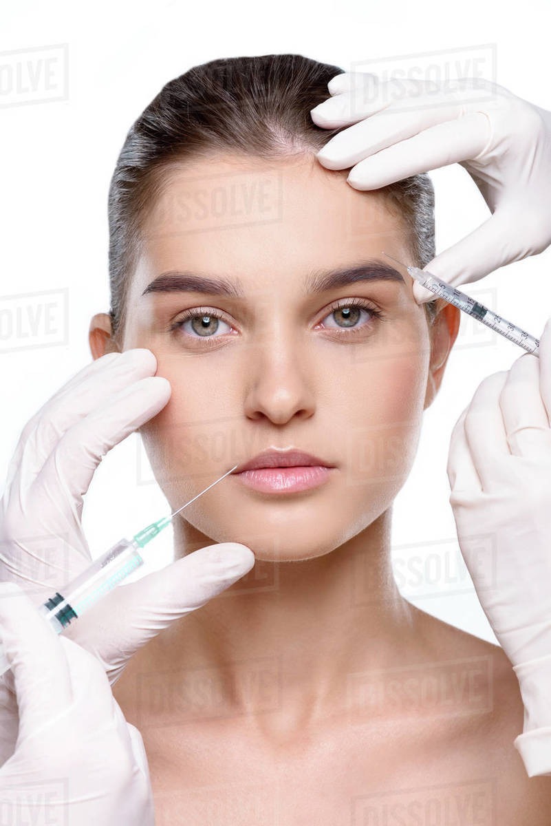 Portrait of attractive woman getting injection isolated on white ...