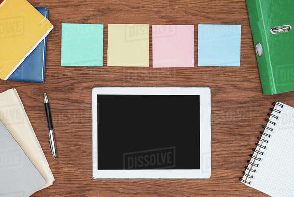 Top view of four sticky notes and digital tablet with blank screen on ...