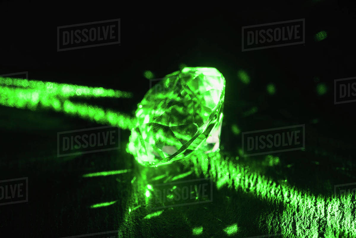 Pure diamond with bright green neon ray on dark background - Stock ...