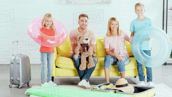 Happy family packing baggage for summer vacation, travel concept ...