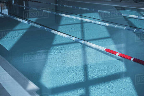 Deep calm blue water with shadows in swimming pool - Stock Photo - Dissolve