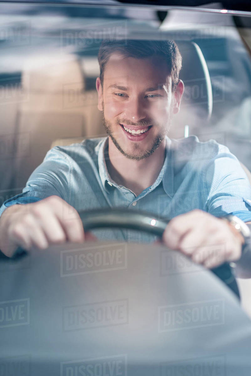 portrait of young smiling man driving car - Royalty-free Stock Photo ...