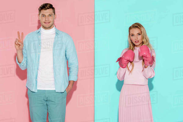 man looking at camera and showing peace sign while woman posing in ...