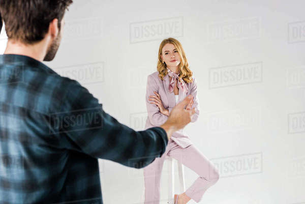 Cropped shot of photographer talking with beautiful female model in ...