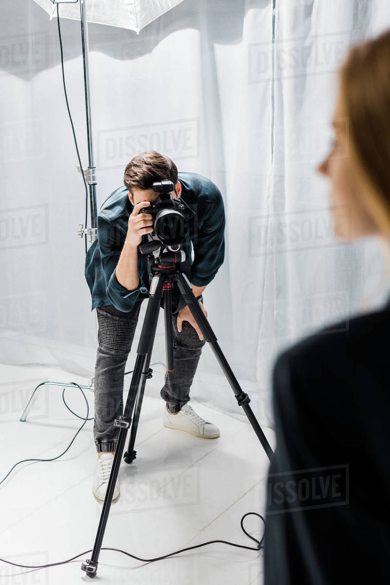 Cropped shot of young photographer shooting beautiful female model in ...