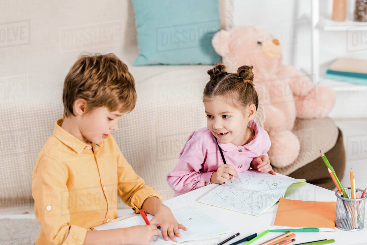 Adorable little children sitting and studying together - Royalty-free ...