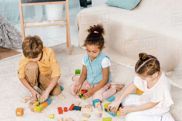 High angle view of adorable multiracial children playing with colorful ...