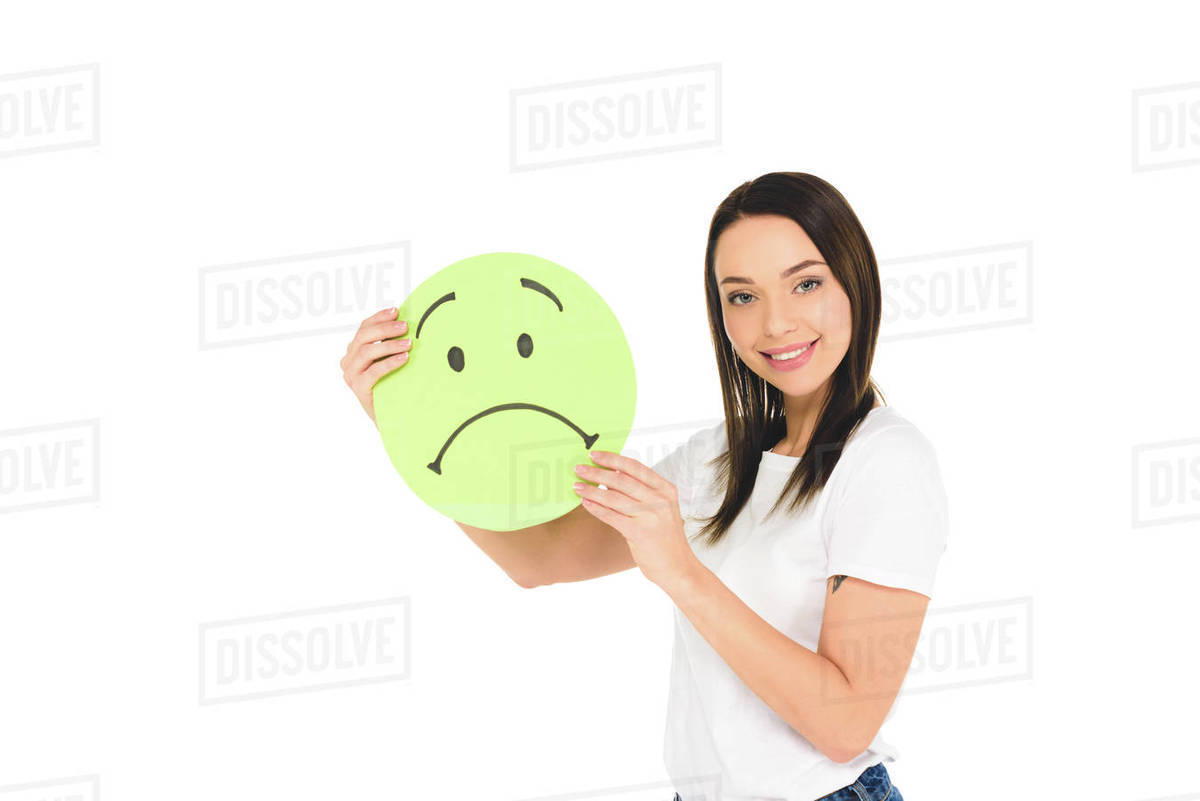 Attractive woman holding green sign with sad face expression while ...