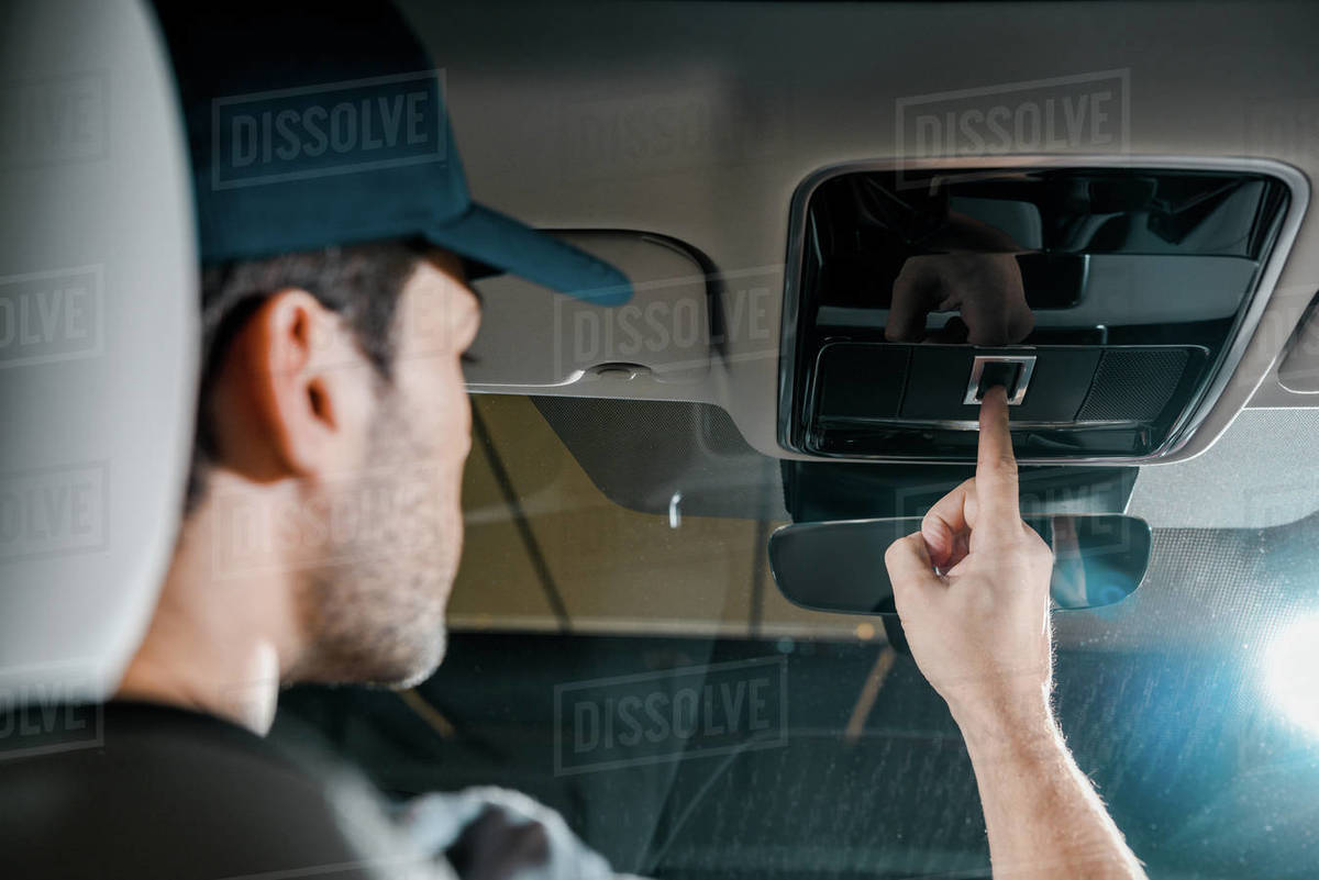 Back view of auto mechanic checking automobile details - Royalty-free ...