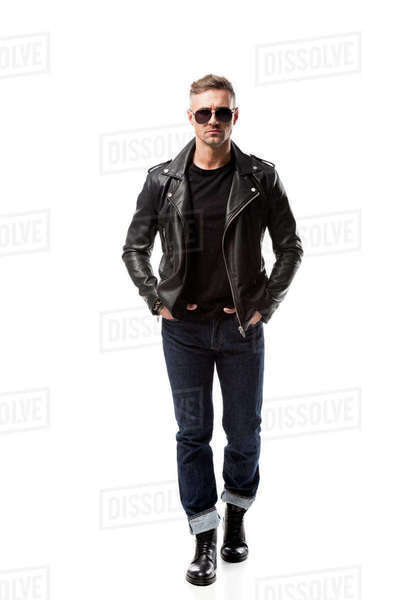 Stylish adult man in leather jacket with hands in pockets isolated on ...