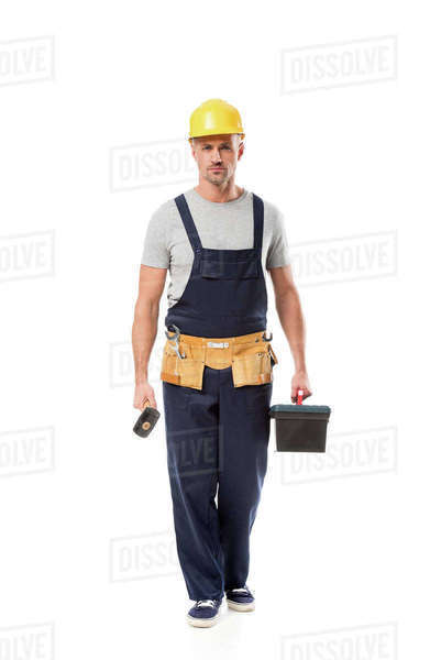 Construction worker holding hammer, tool box and looking at camera ...
