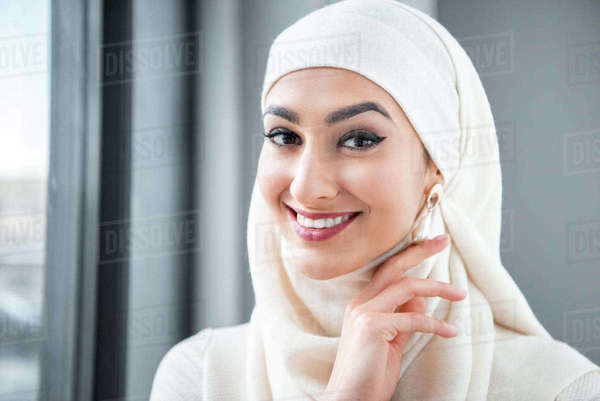 Portrait of beautiful happy young muslim woman smiling at camera ...