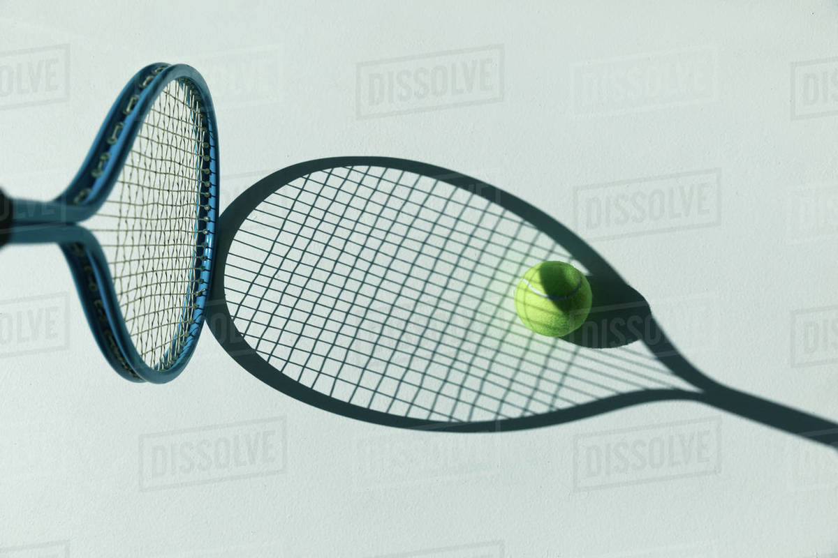Tennis racket and ball on the floor at room with daylight - Royalty ...