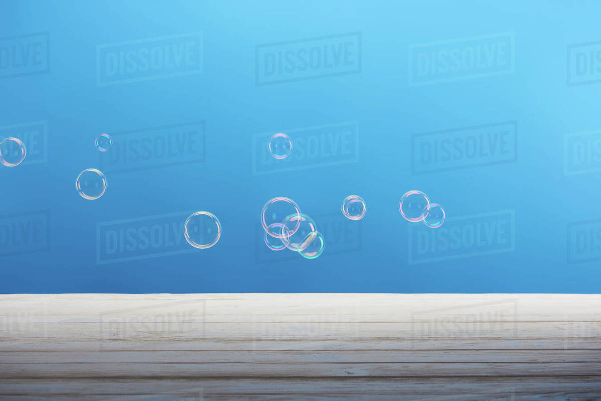 Clean laundry soap bubbles on blue background - Stock Photo - Dissolve