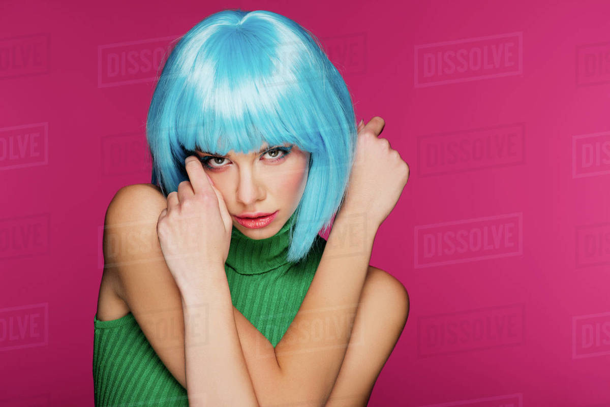 Beautiful model with blue hair, isolated on pink - Stock Photo - Dissolve