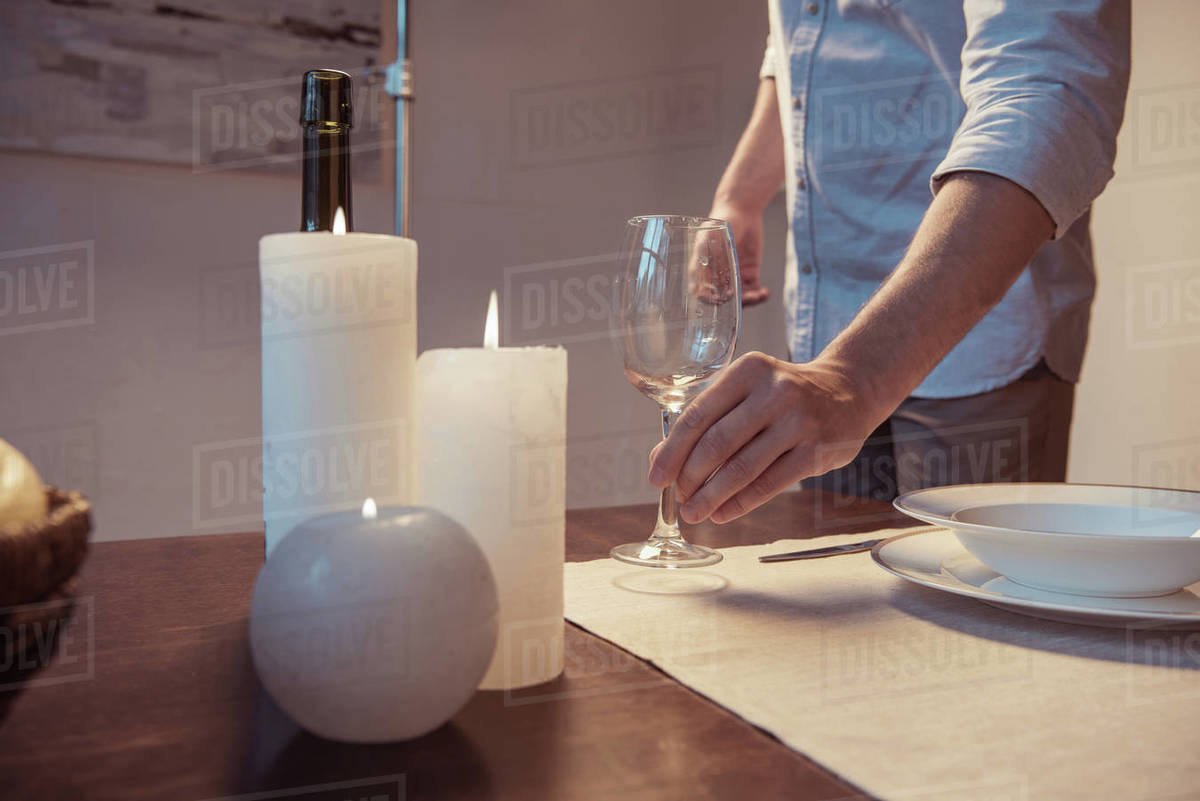 Cropped shot of man serving table for romantic dinner - Royalty-free ...