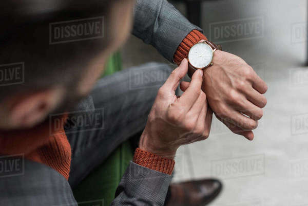 Close up view of man in formal wear adjusting watch on hand - Royalty ...