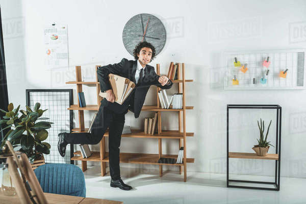 Hurrying businessman with folders running in office not to miss ...