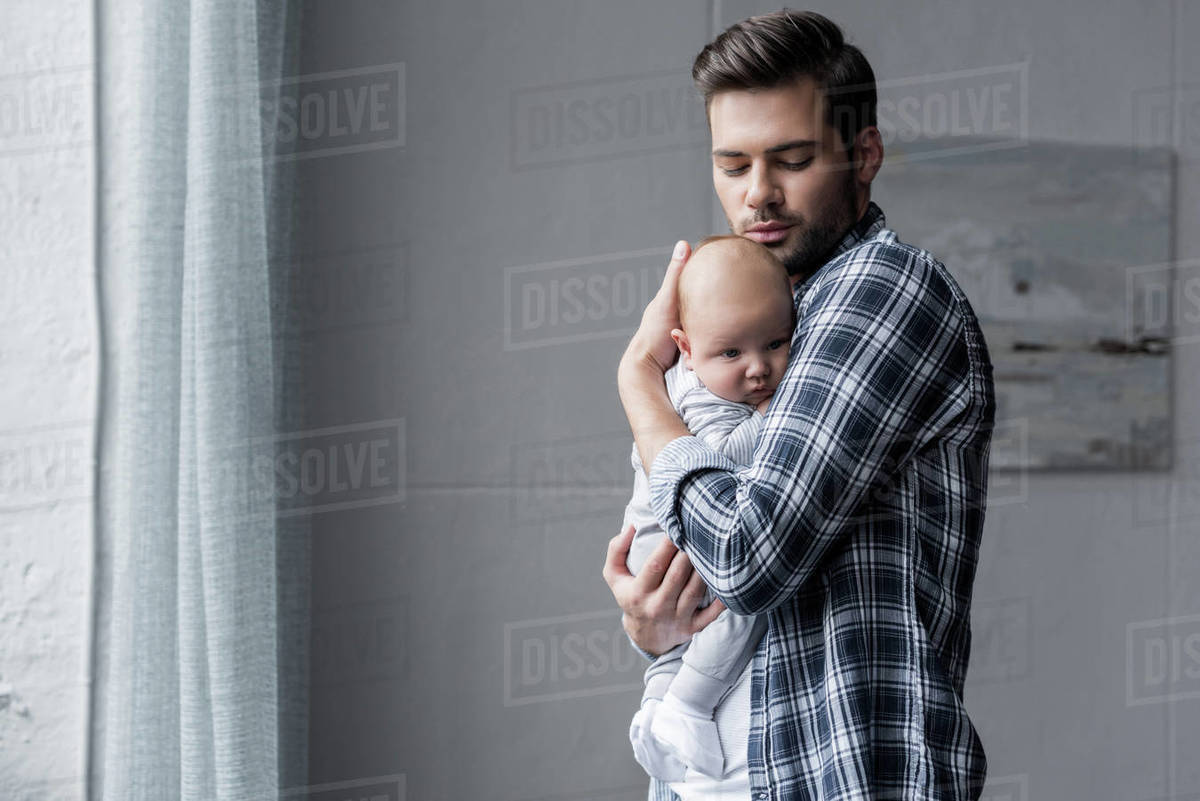 Handsome father hugging his cute newborn son - Royalty-free Stock Photo ...