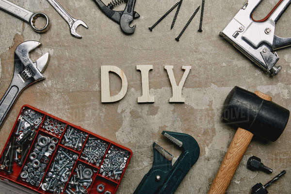 Top view of do it yourself sign and various carpentry tools arranged on ...