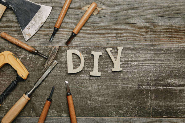Top view of different carpentry tools and diy sign on wooden background ...