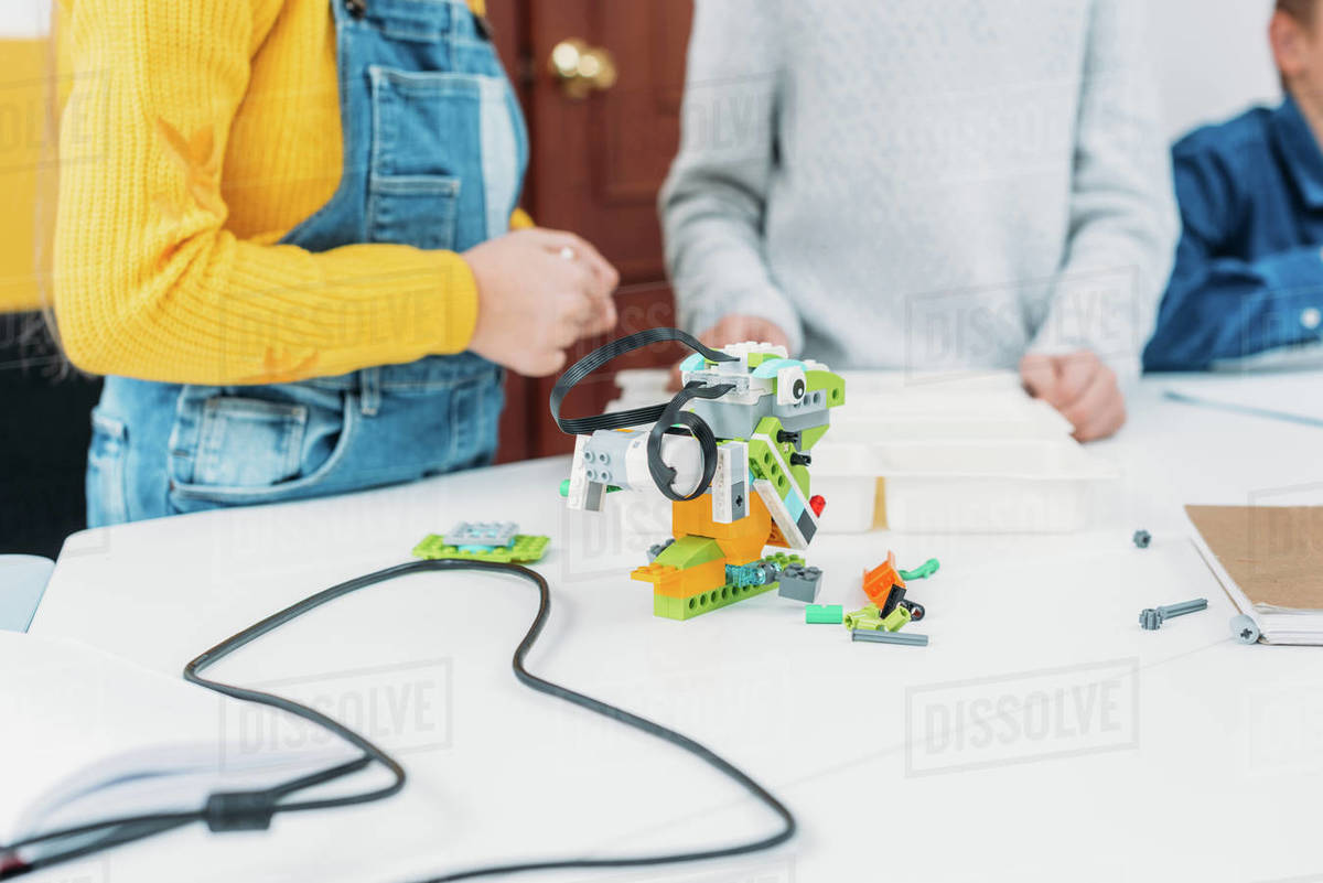 Partial view of children working together on stem project in classroom ...