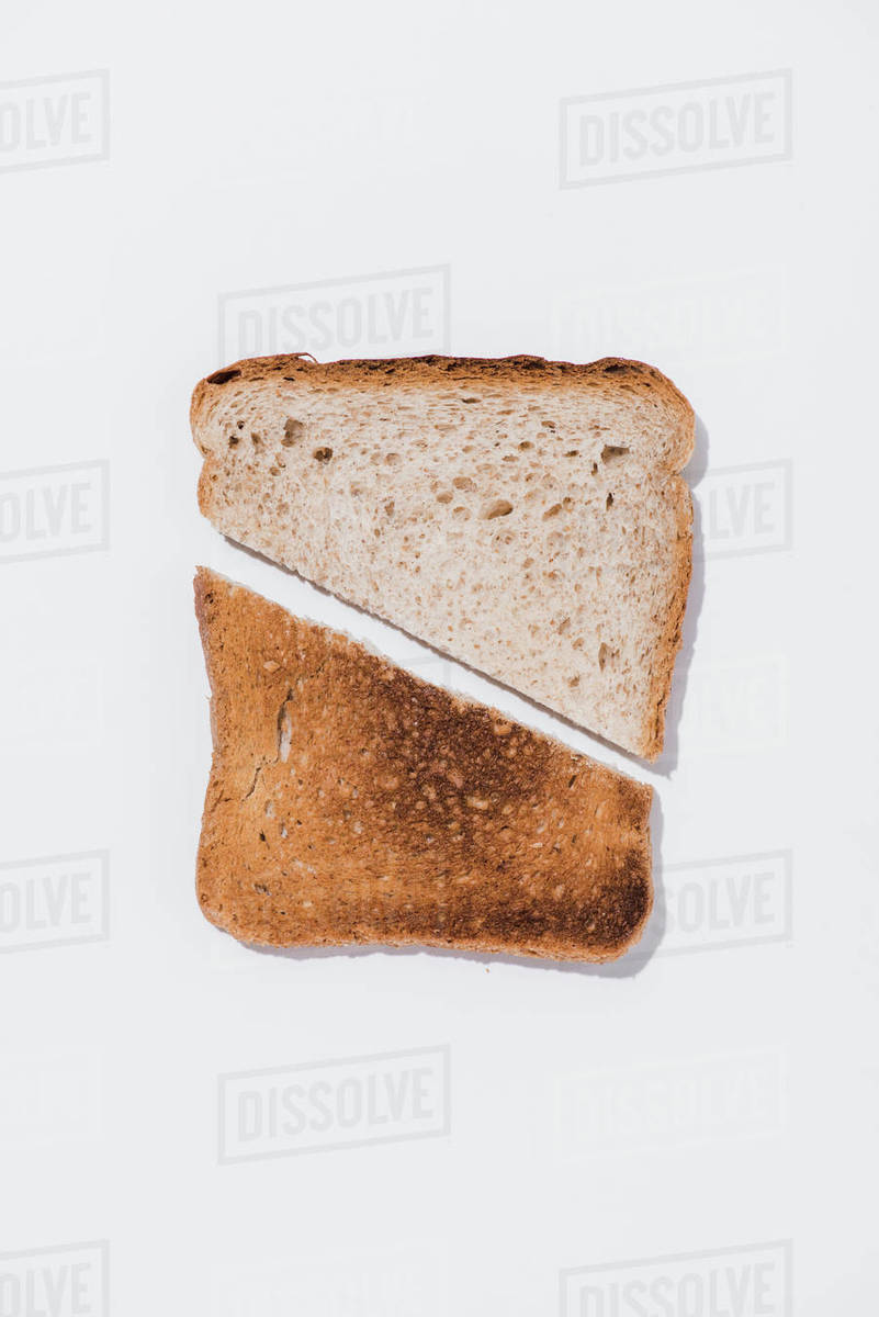 Top view of slice of bread with roasted half on white surface - Stock ...