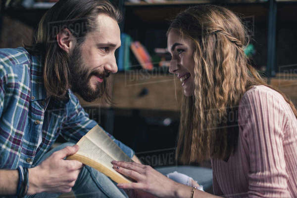 Happy young couple reading book together - Royalty-free Stock Photo ...