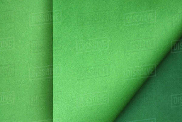 Top view of green paper on colored background - Stock Photo - Dissolve