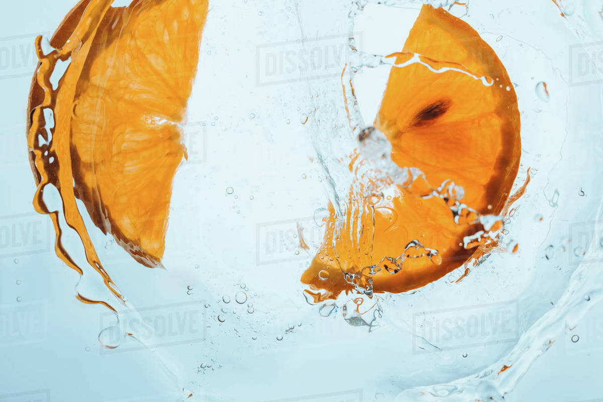 Fresh orange slices floating in water with splash - Royalty-free Stock ...