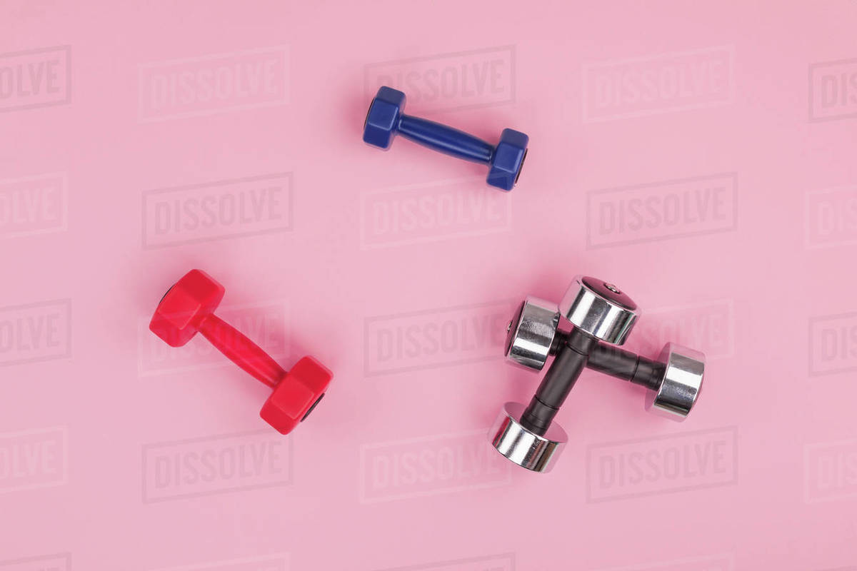 Top view of set of various dumbbells isolated on pink - Royalty-free ...
