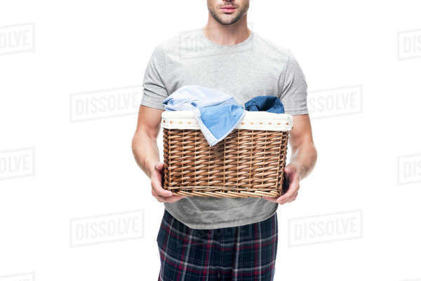 Cropped shot of handsome man with basket of laundry isolated on white ...