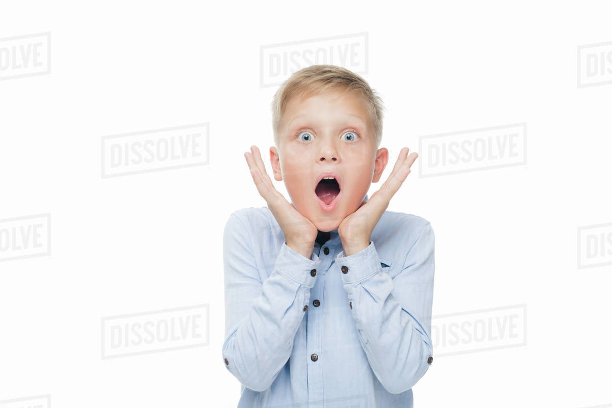 portrait of shocked caucasian little boy looking at camera isolated on ...