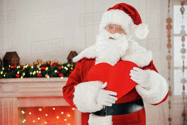 santa claus in traditional red costume holding red heart sign - Royalty ...