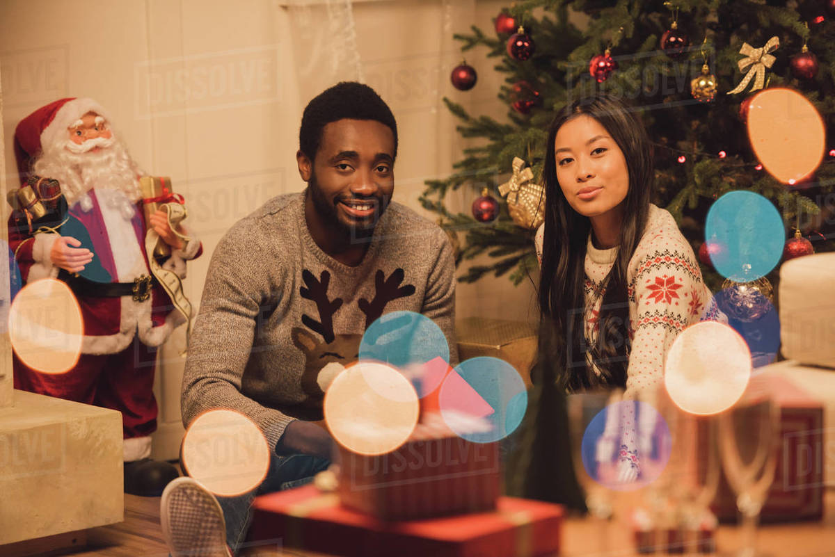 multiethnic couple celebrating christmas together at home - Royalty ...