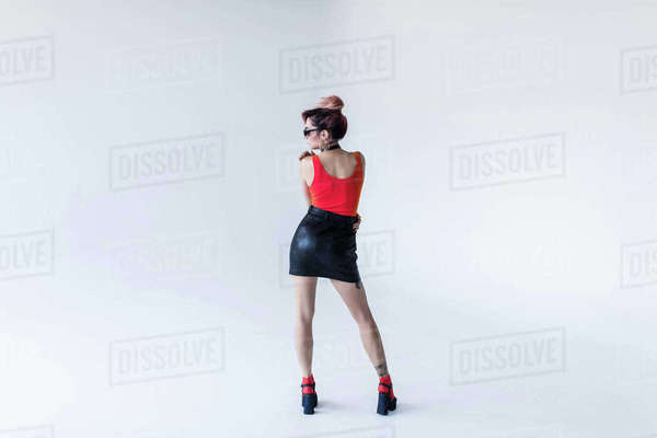 Back view of stylish girl posing for fashion shoot, isolated on white ...