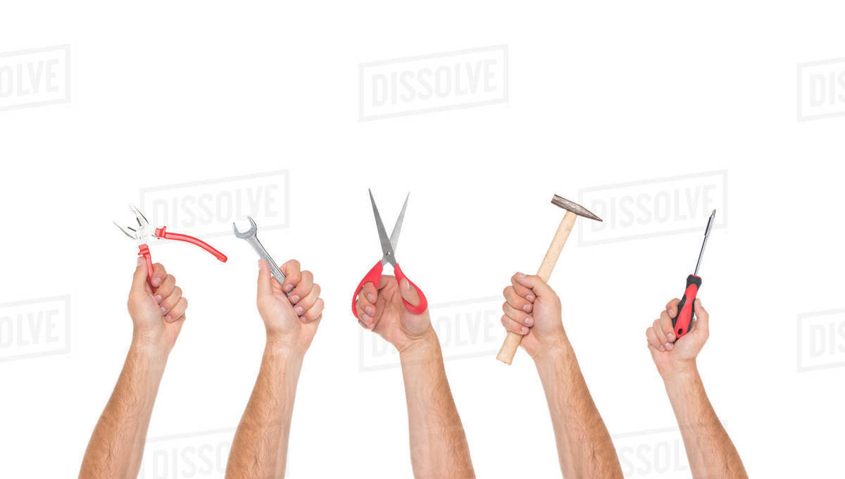 Cropped shot of human hands holding various tools isolated on white ...