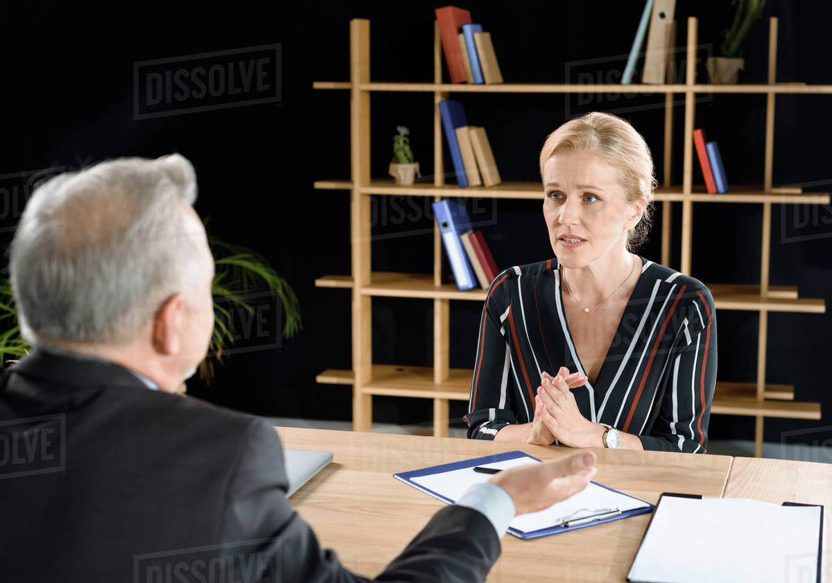 desperate mature woman asking businessman for advice - Royalty-free ...