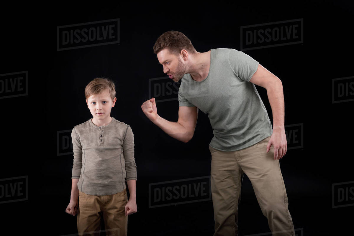 Angry father threatening and gesturing to scared little son, family ...