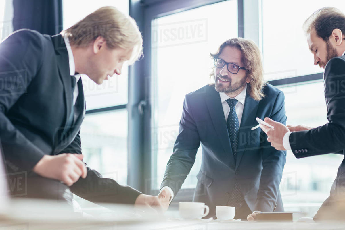 Professional middle aged businessmen working together in office ...