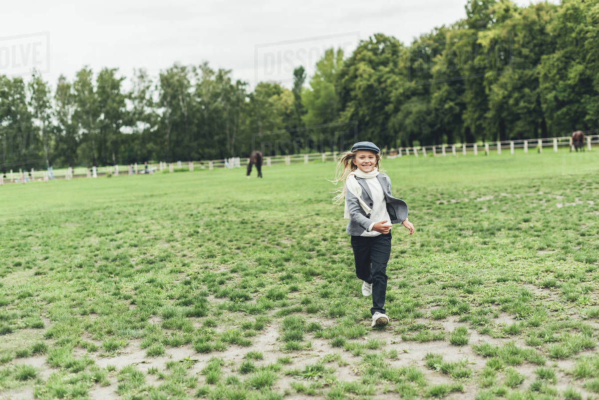 Cheerful adorable blonde kid running at countryside - Royalty-free ...